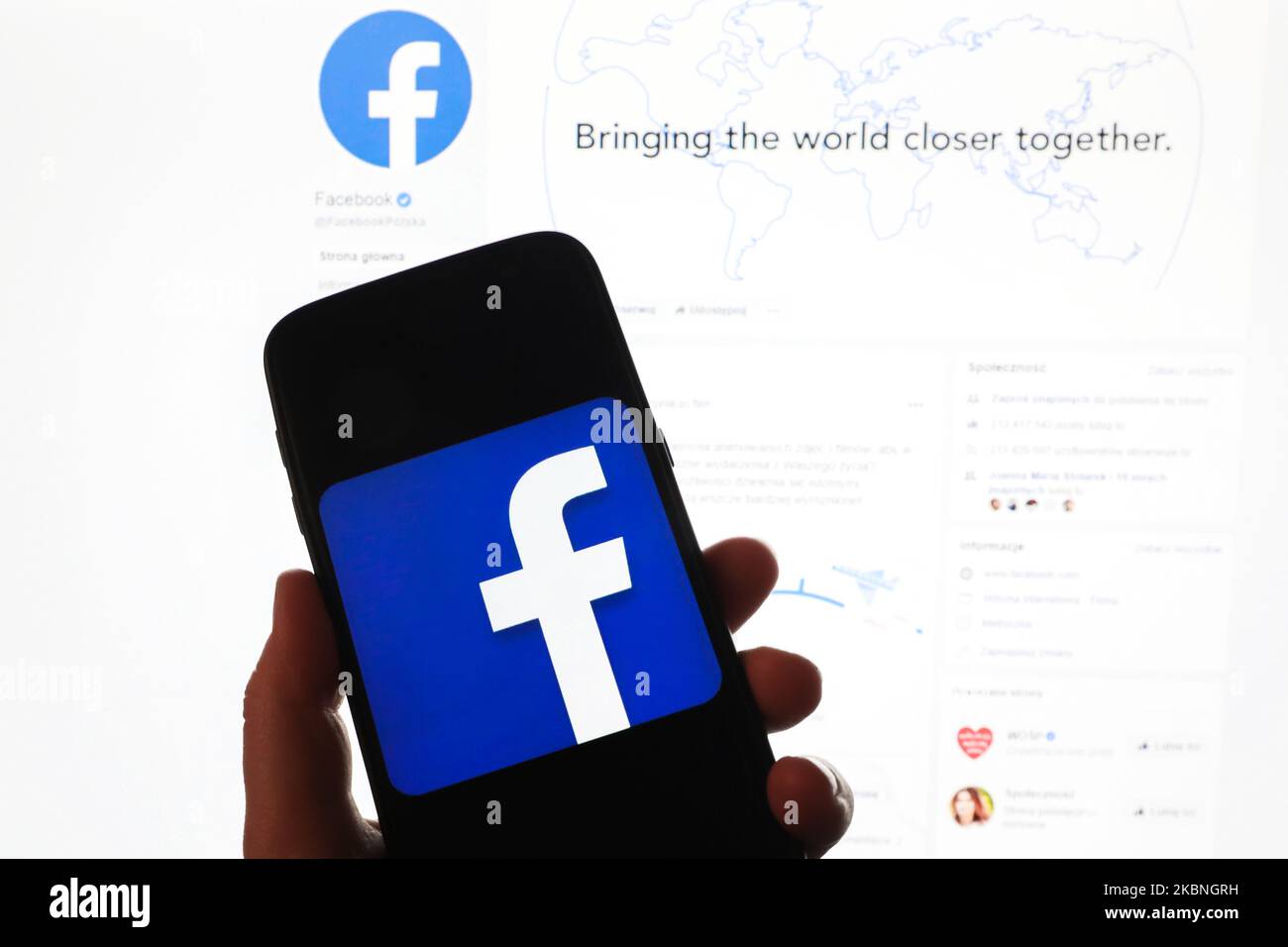 Facebook logo is displayed on a mobile phone screen photographed for ...
