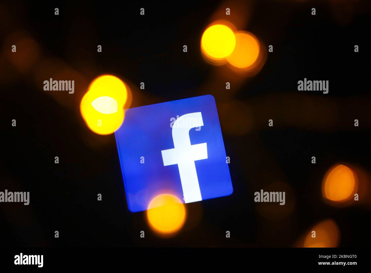 Facebook logo is displayed on a mobile phone screen photographed for ...