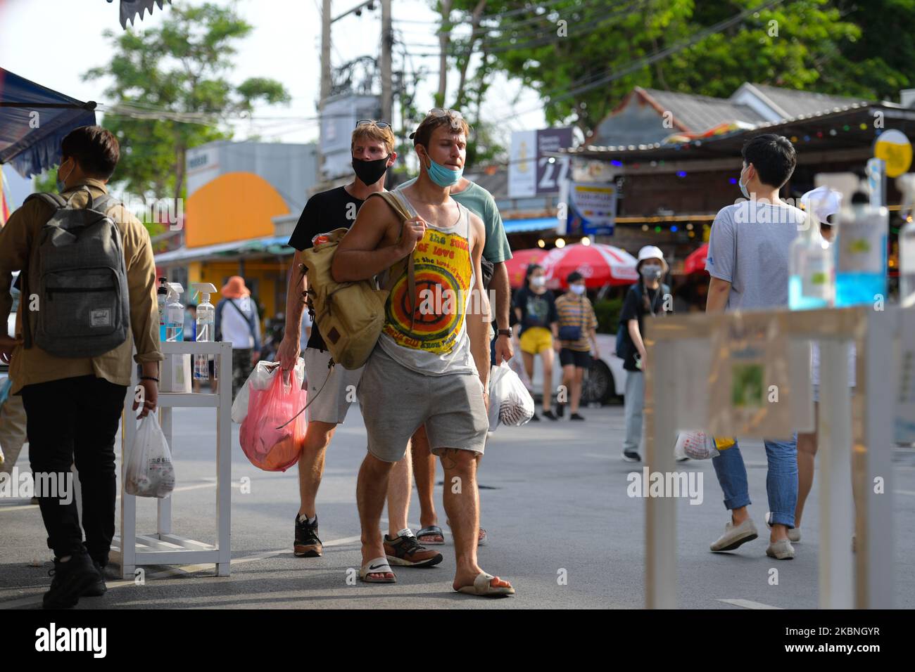 Foreign tourists wear face masks as a preventive measure at Chatuchak ...