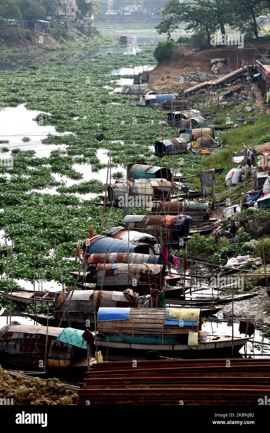A row of narrow boats belonging to gypsies moored on the Turag River in ...