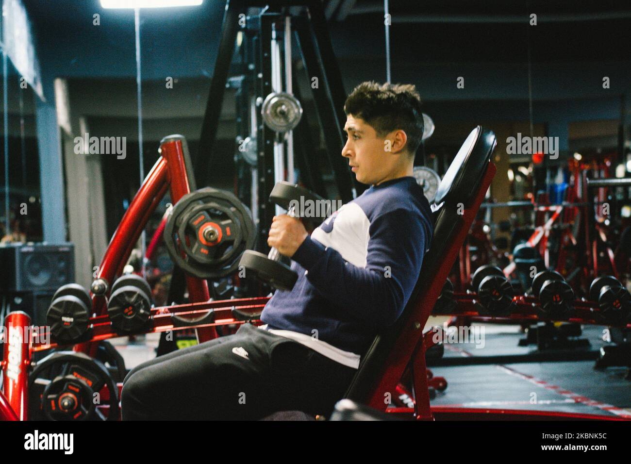 a customer trains on a fitness machine in World gym cologne as the ...