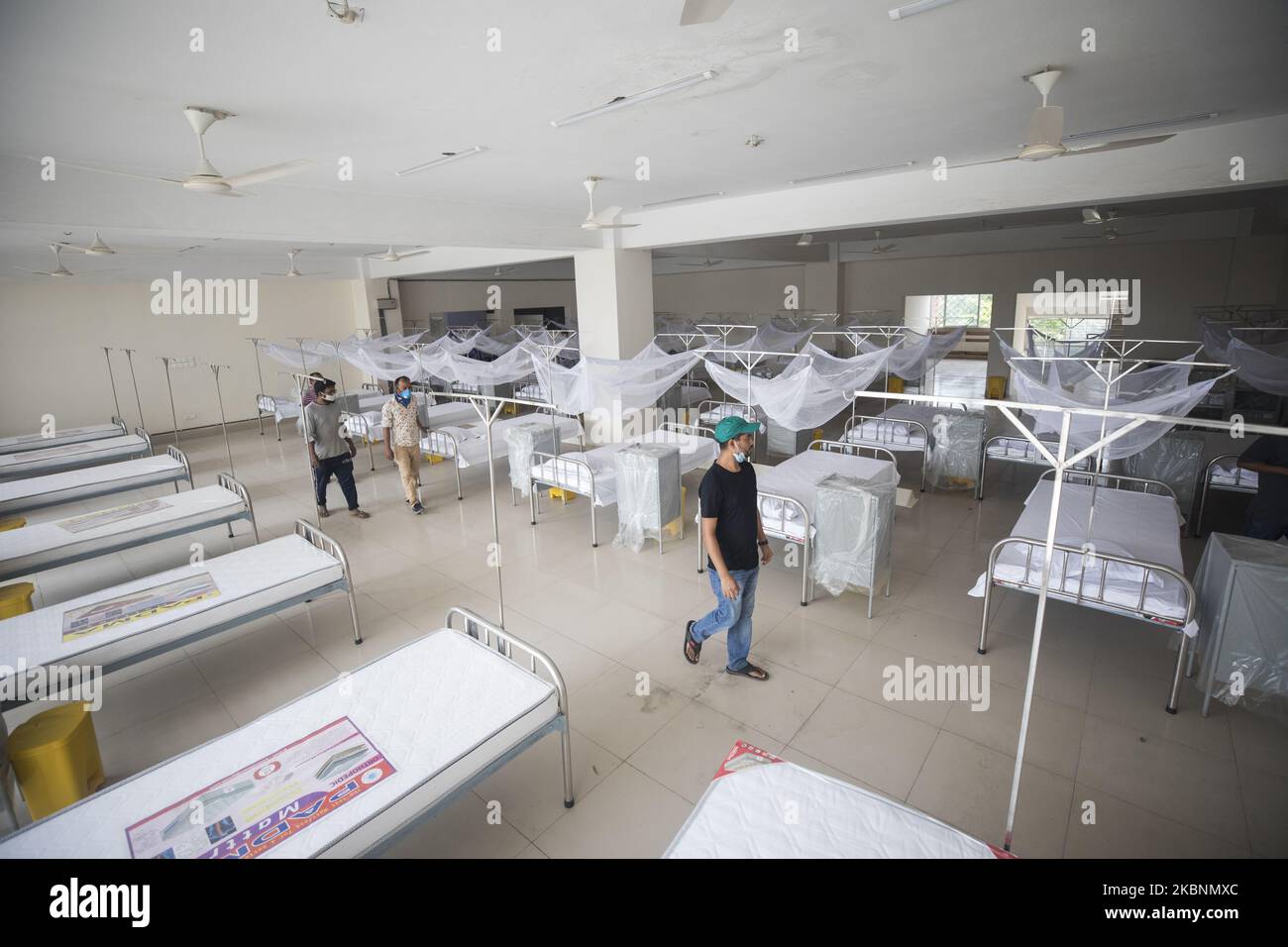 Workers preparing the makeshift quarantine hospital in Mohakhali DNCC ...