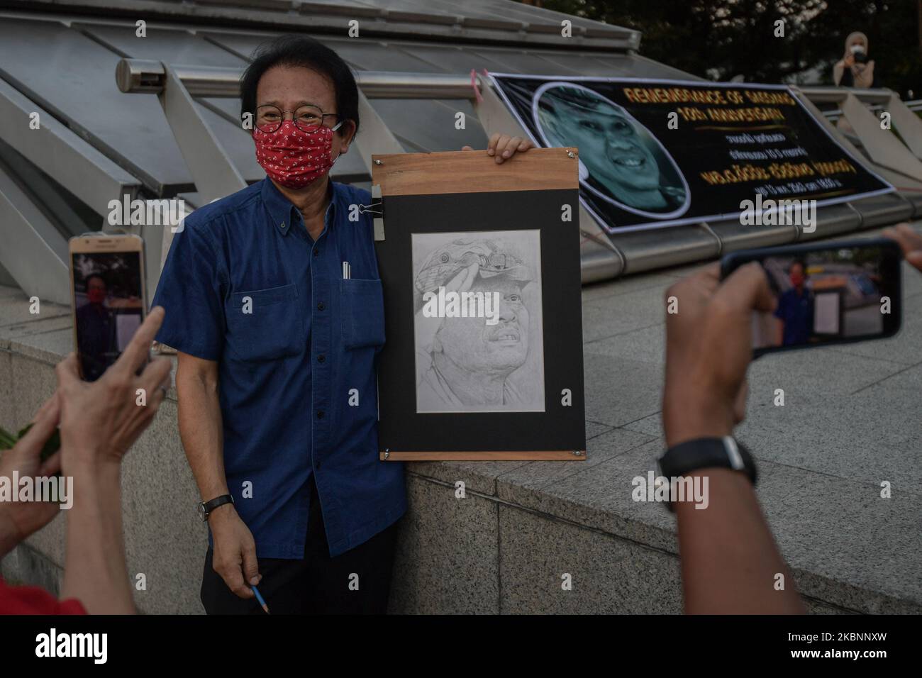 Protester red shirt demonstrators in protests 2010 while a drawing is ...