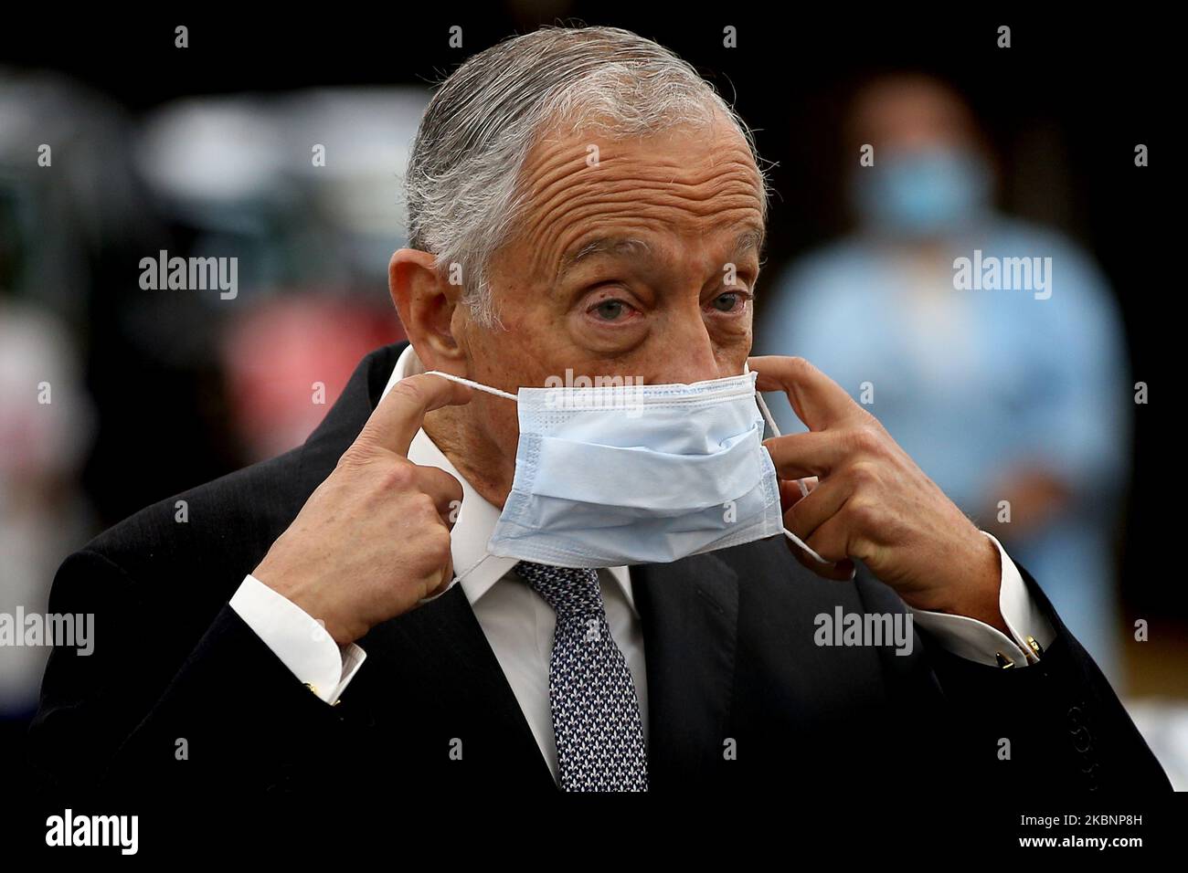 Portuguese President Marcelo Rebelo de Sousa adjusts his face mask ...
