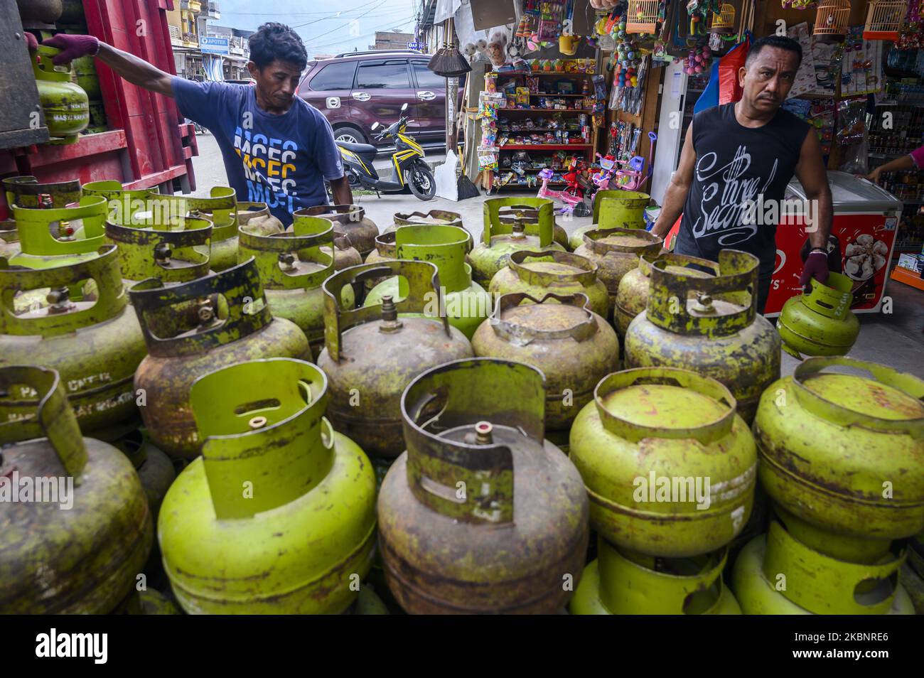 Workers unload subsidized LPG (Liquified Petroleum Gas) from trucks ...
