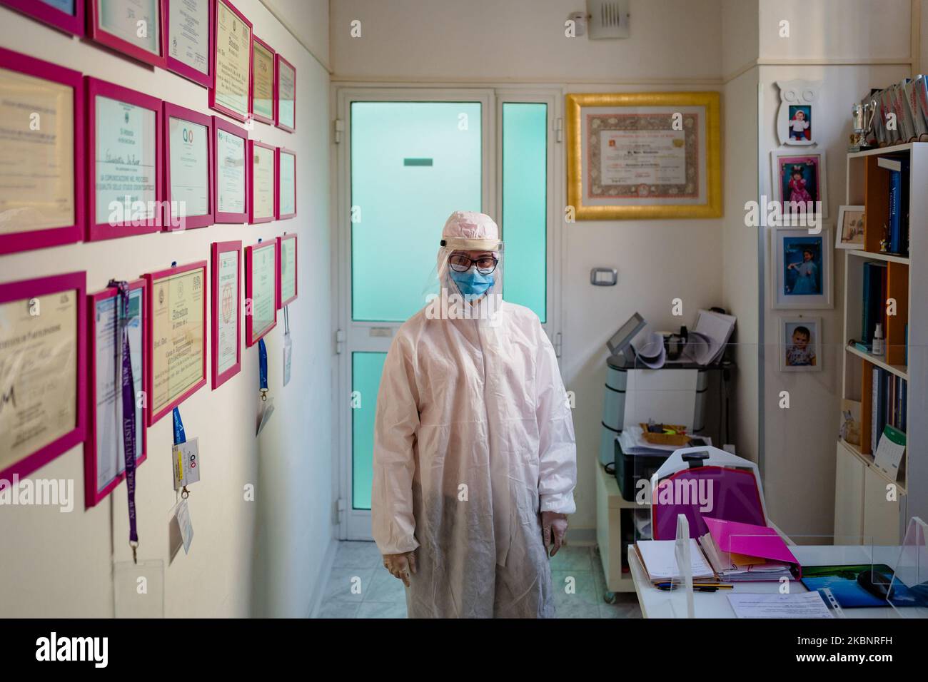 Dental office secretary poses while at work adopting all safety ...