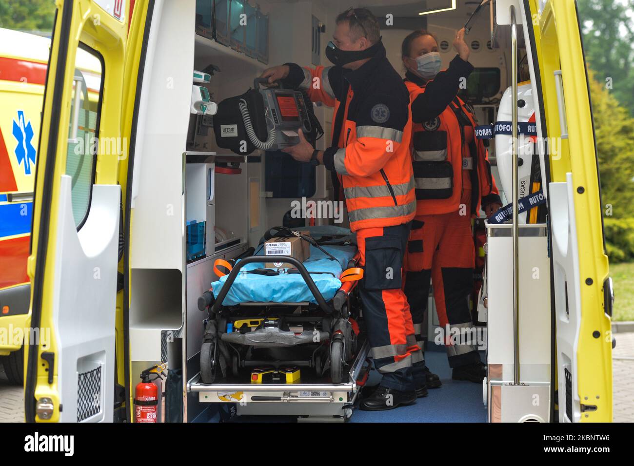 Two paramedics seen inside of a new ambulance. Today, two hospitals in ...