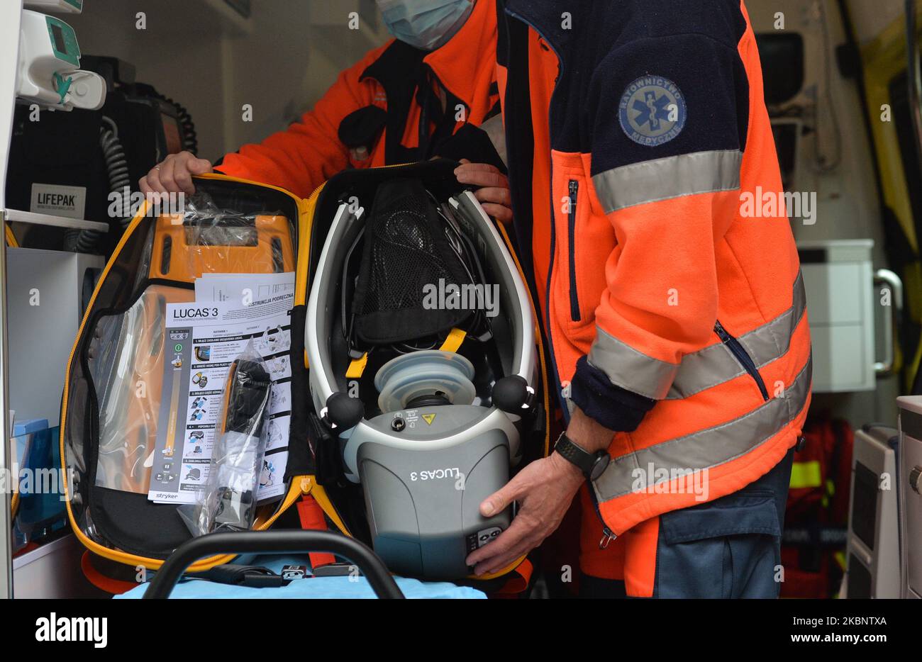 A paramedic holds the LUCAS device, an easy-to-use mechanical chest ...