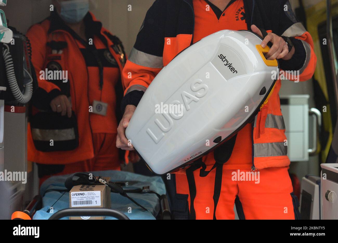 A paramedic holds the LUCAS device, an easy-to-use mechanical chest ...
