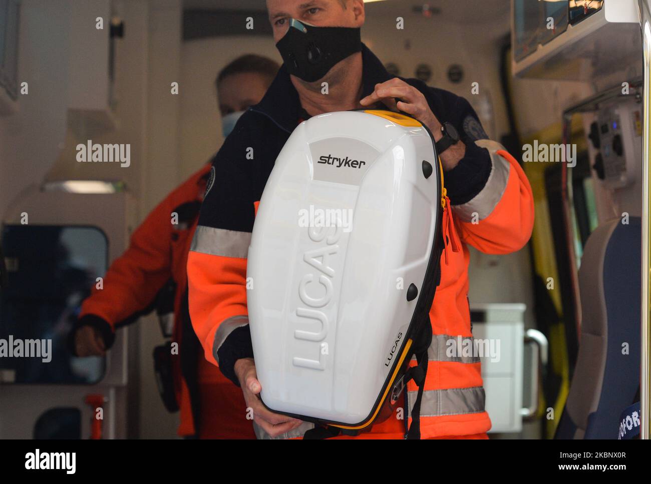 A paramedic holds the LUCAS device, an easy-to-use mechanical chest ...
