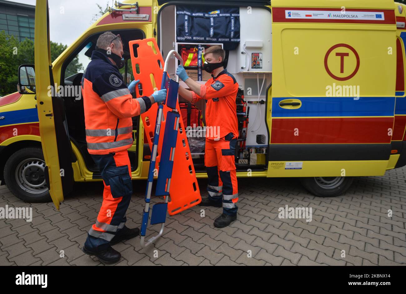Paramedics checking the equipment of a new ambulance. Today, two ...