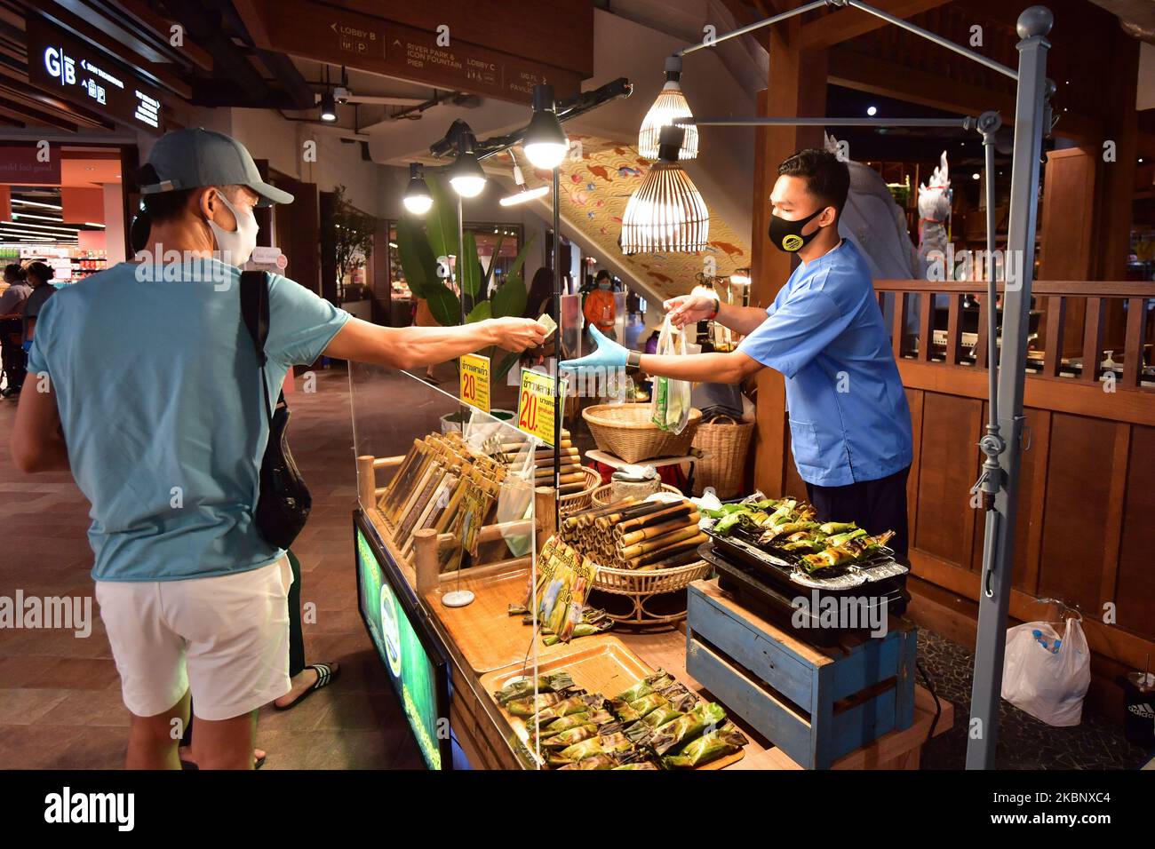 A food vendor wear face mask and gloves as a preventive measure attends ...