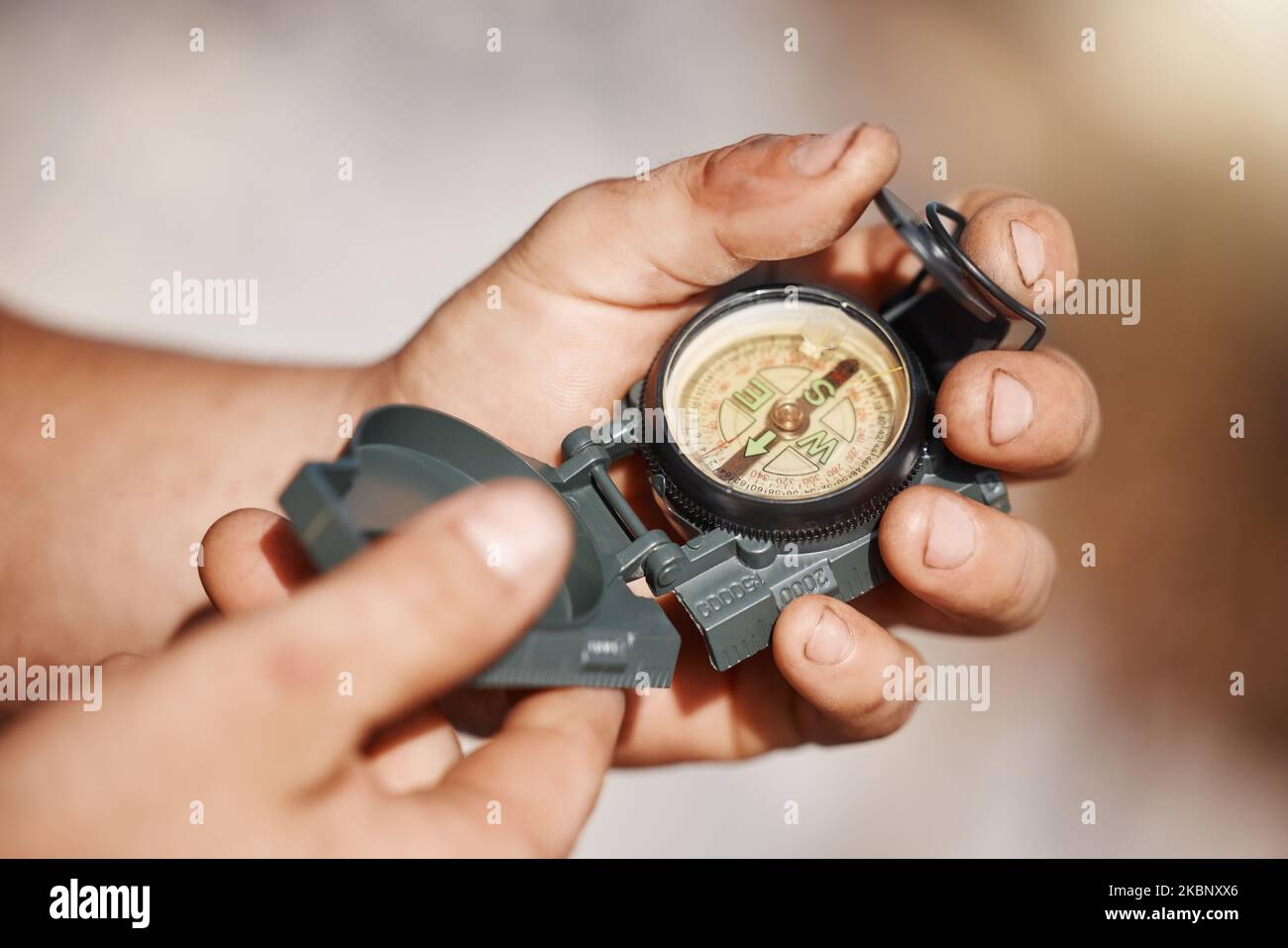 Hiking man, hands or pocket compass in travel location, camping ground ...