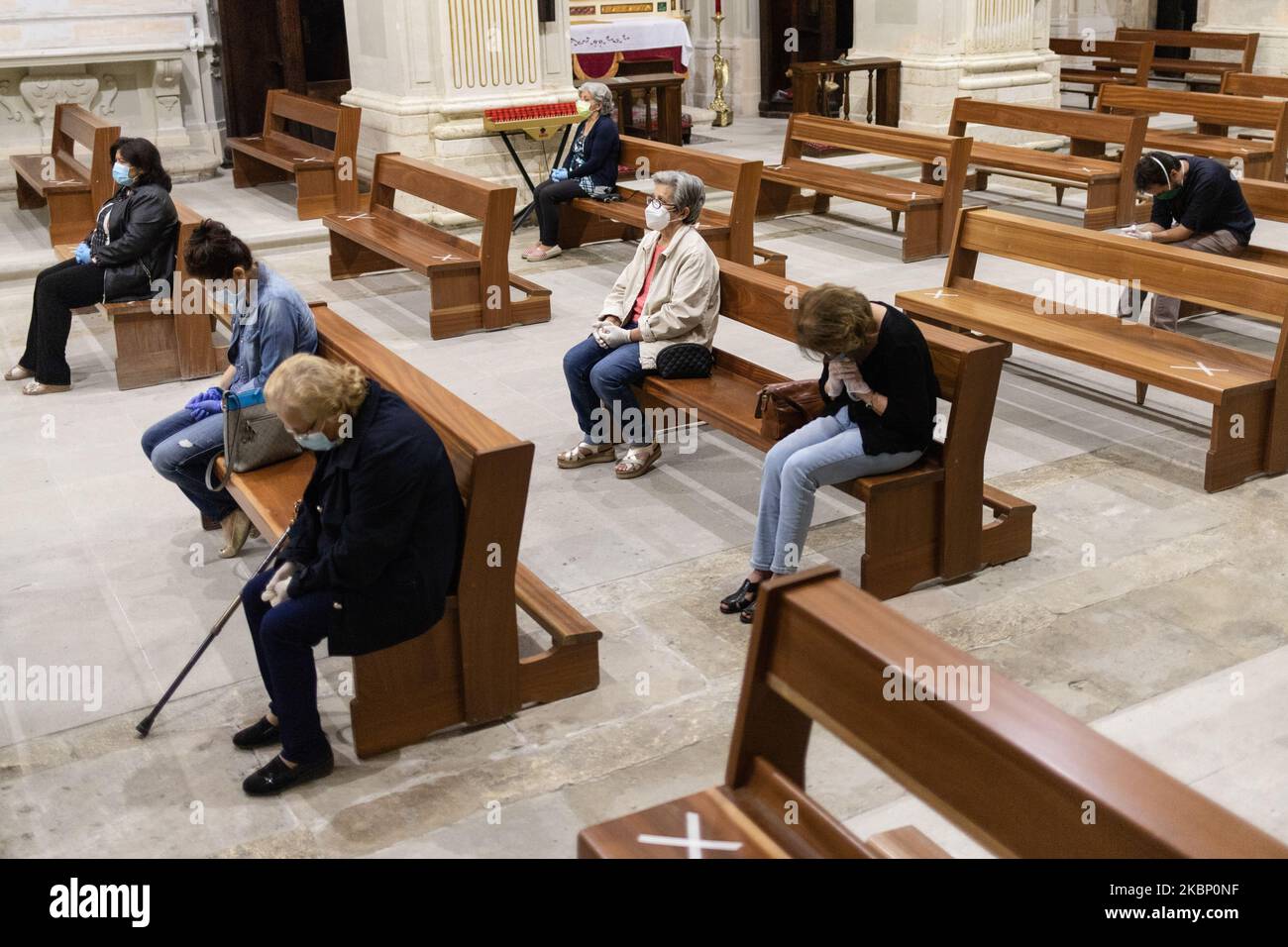 Faithful with masks and spaced from each other, participate in the ...