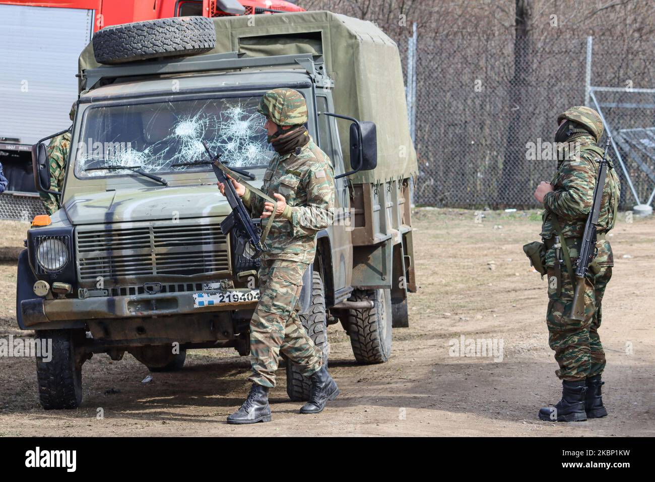 Vehicle of the Greek army damaged by stones from protesting migrants ...