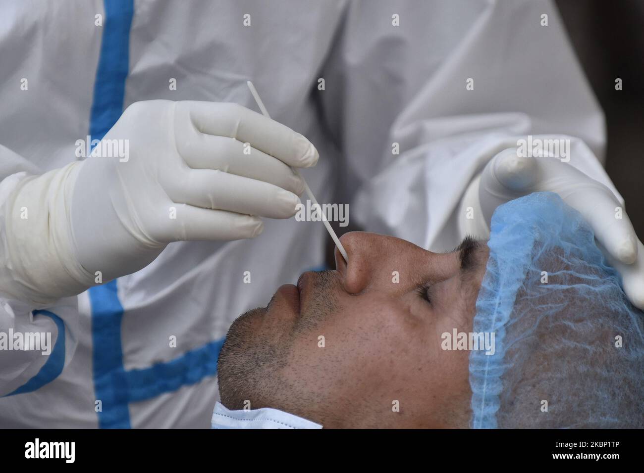 A Nepalese Health personnel in protective gear ready to collect nasal ...