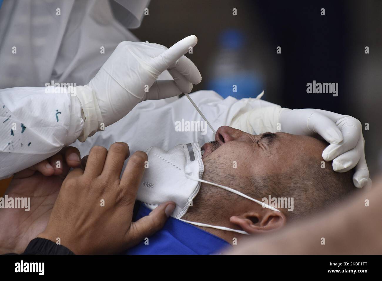 A Nepalese Health personnel in protective gear ready to collect nasal ...