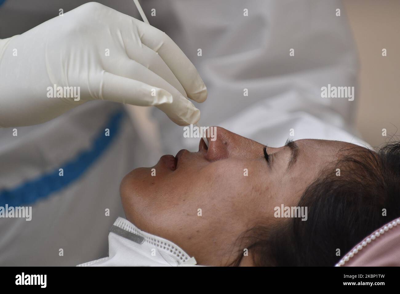 A Nepalese Health personnel in protective gear ready to collect nasal ...