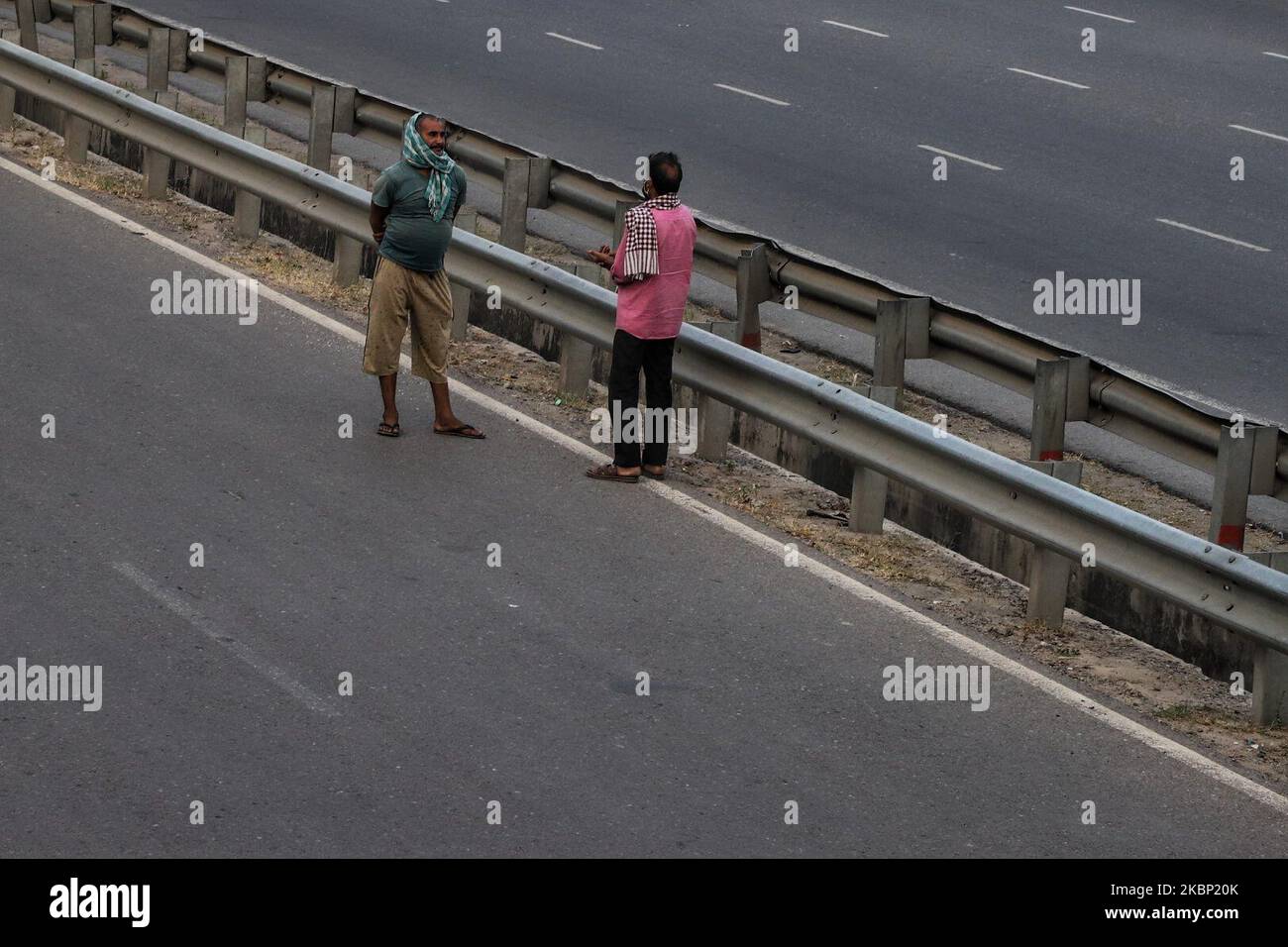 Indian men in conversation while maintaining social distancing amid ...
