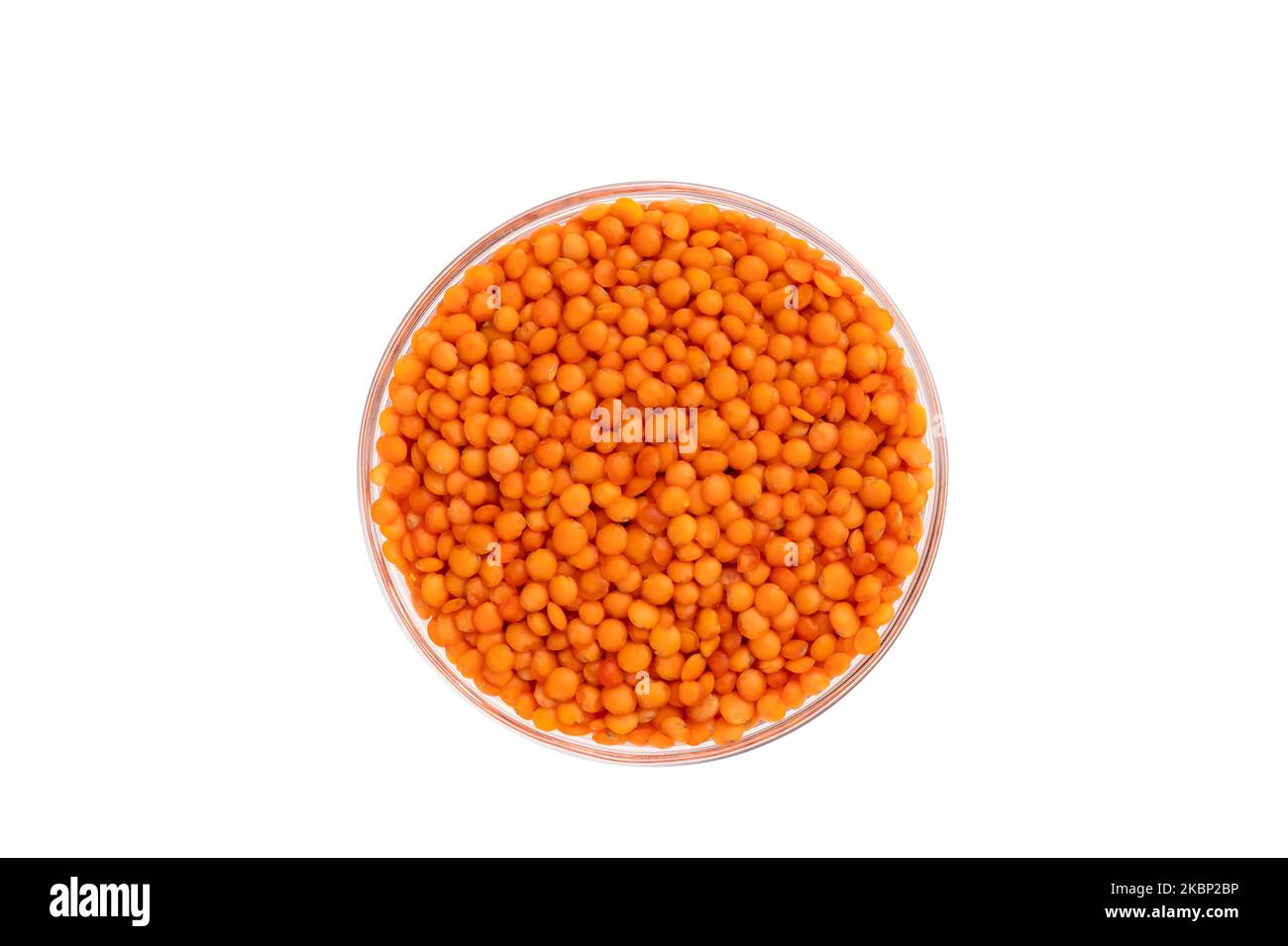 Red lentils seed in a glass bowl isolated on white background, top view ...