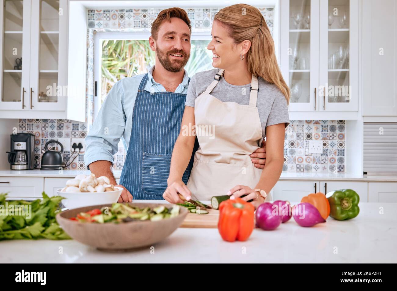 Love, health and happy couple cooking in the kitchen with healthy food ...
