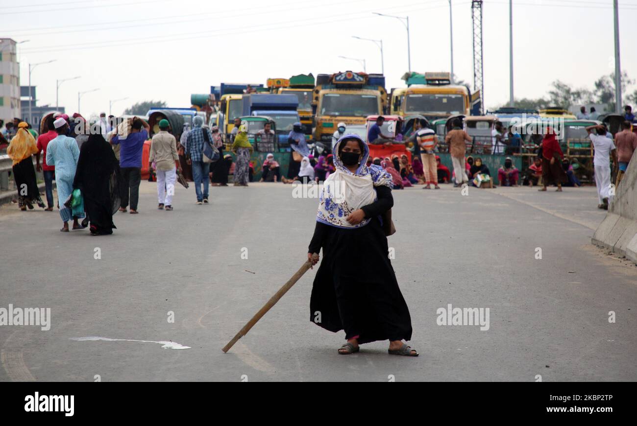 Bangladeshi garment workers block a road as they gather in a protest ...