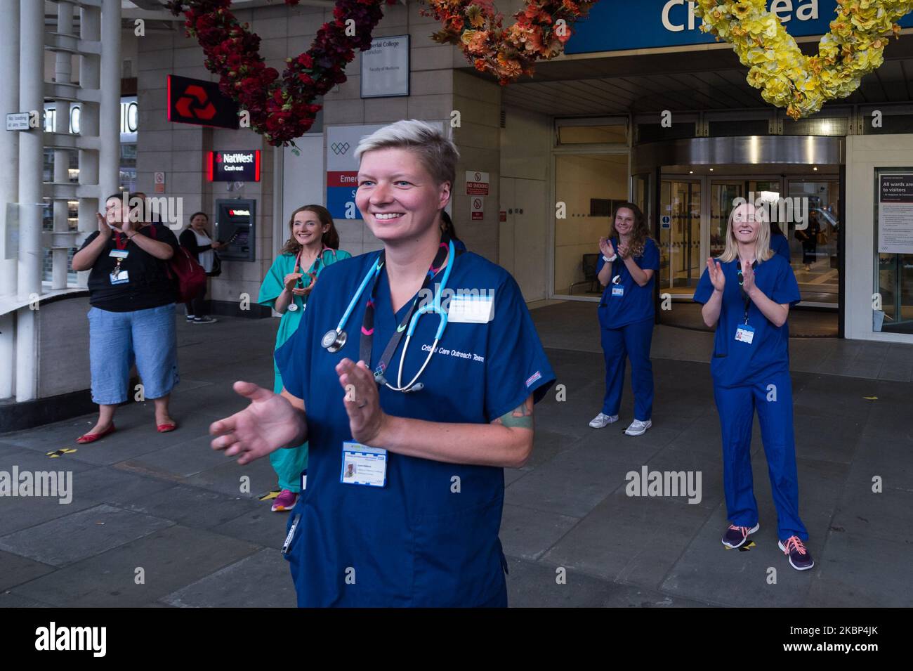 Medical staff clap their hands outside Chelsea and Westminster Hospital ...