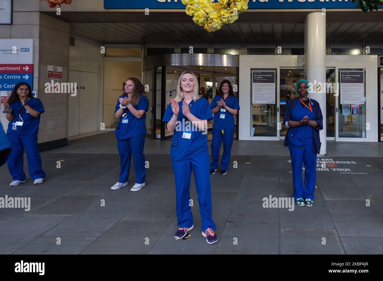 Medical staff clap their hands outside Chelsea and Westminster Hospital ...
