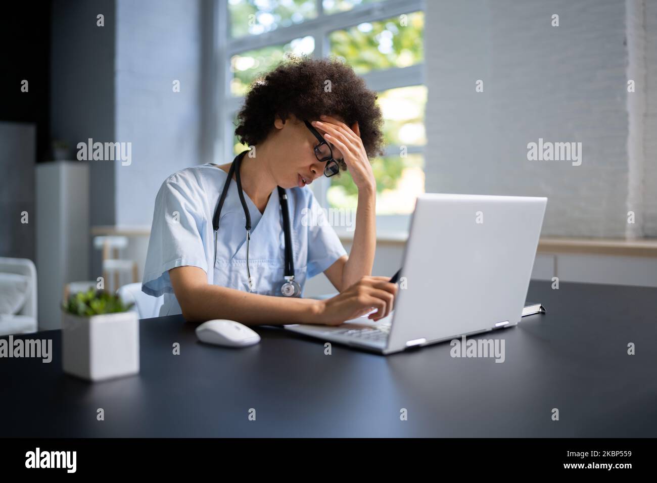 Sad Woman Nurse Stress And Pain. Looking At Computer Stock Photo - Alamy