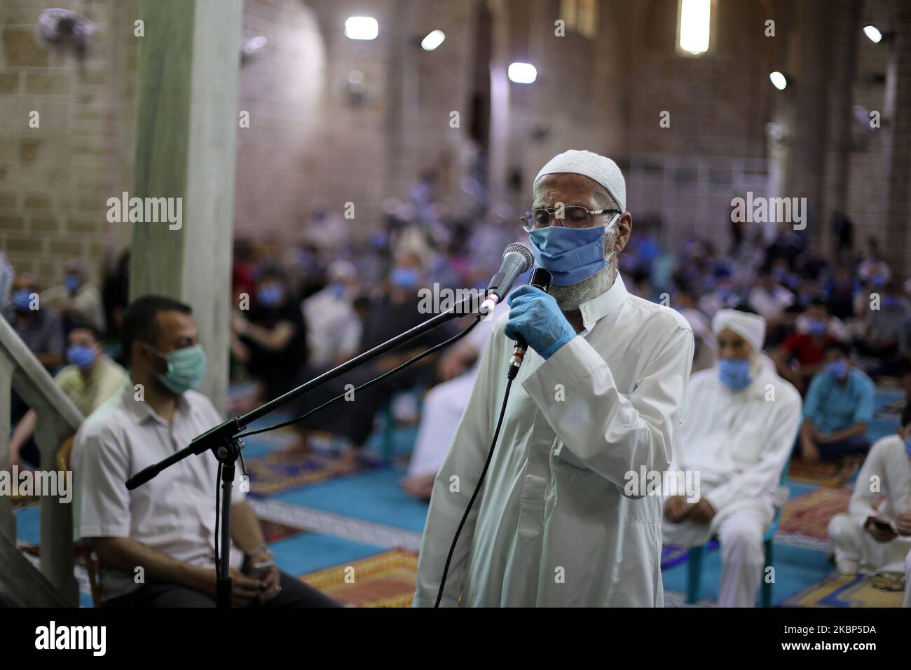 Palestinians wearing masks attend friday prayers in a mosque as hi-res ...