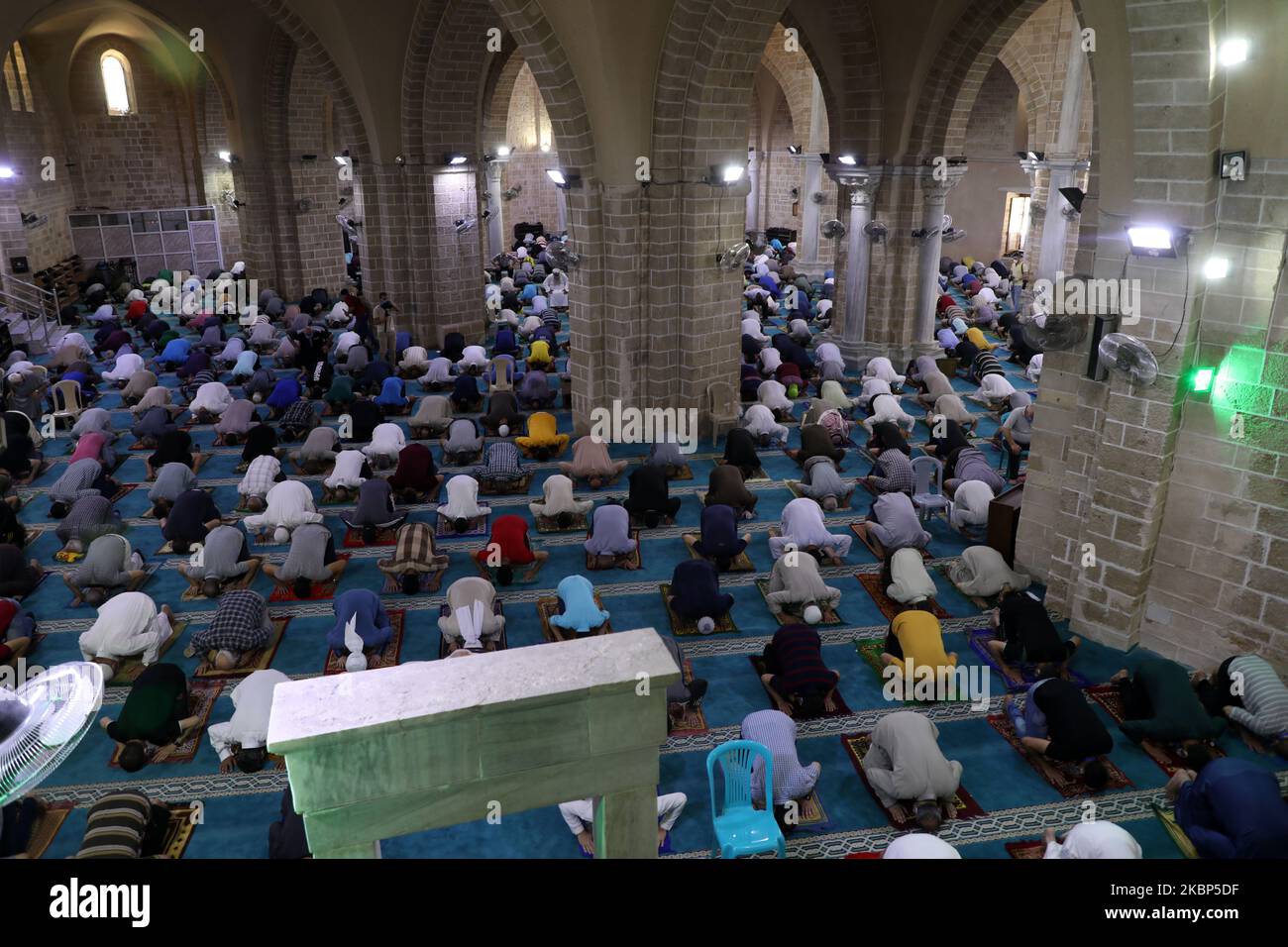 Palestinians wearing masks attend friday prayers in a mosque as hi-res ...