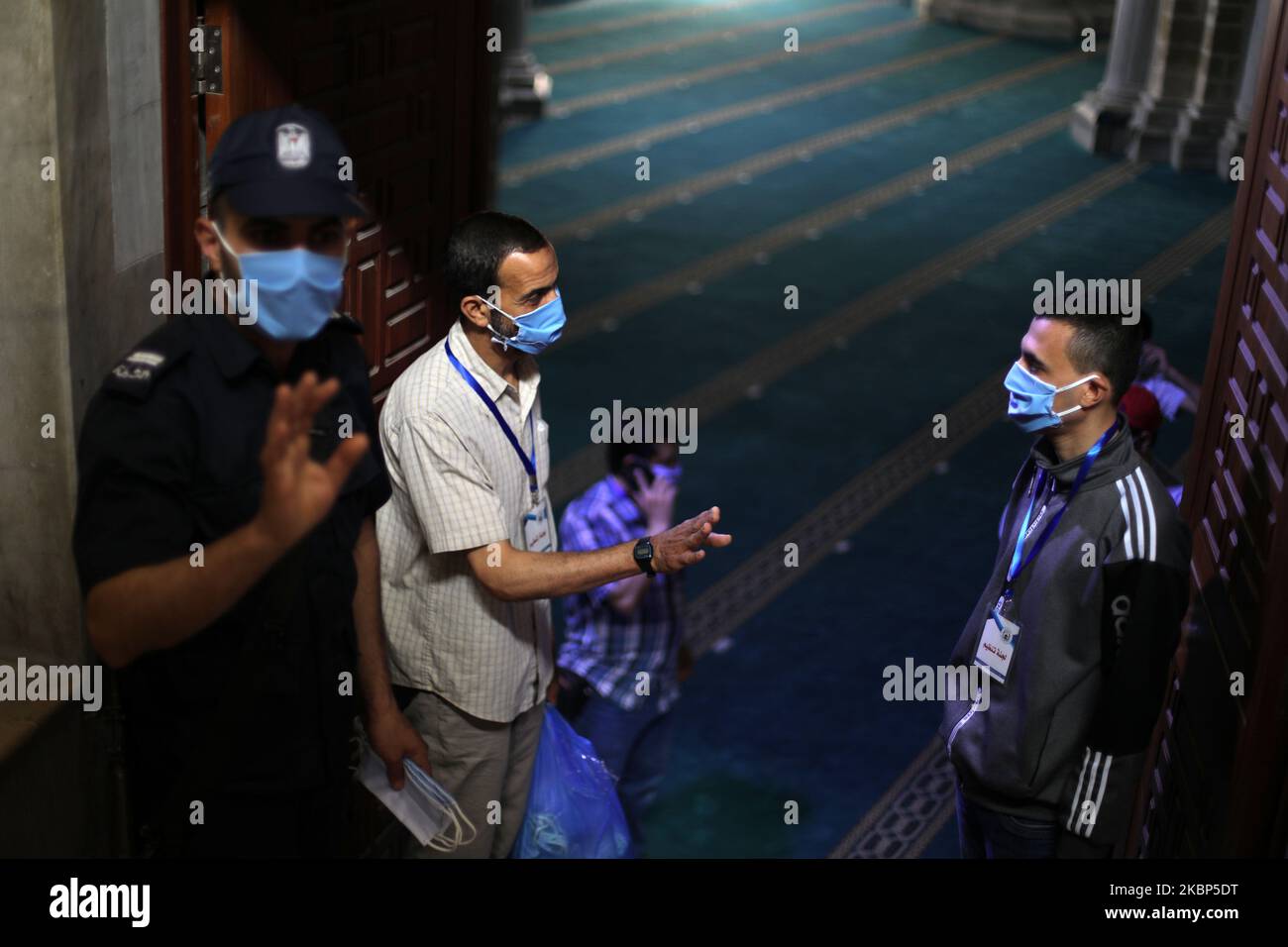 Palestinians wearing masks attend friday prayers in a mosque as hi-res ...