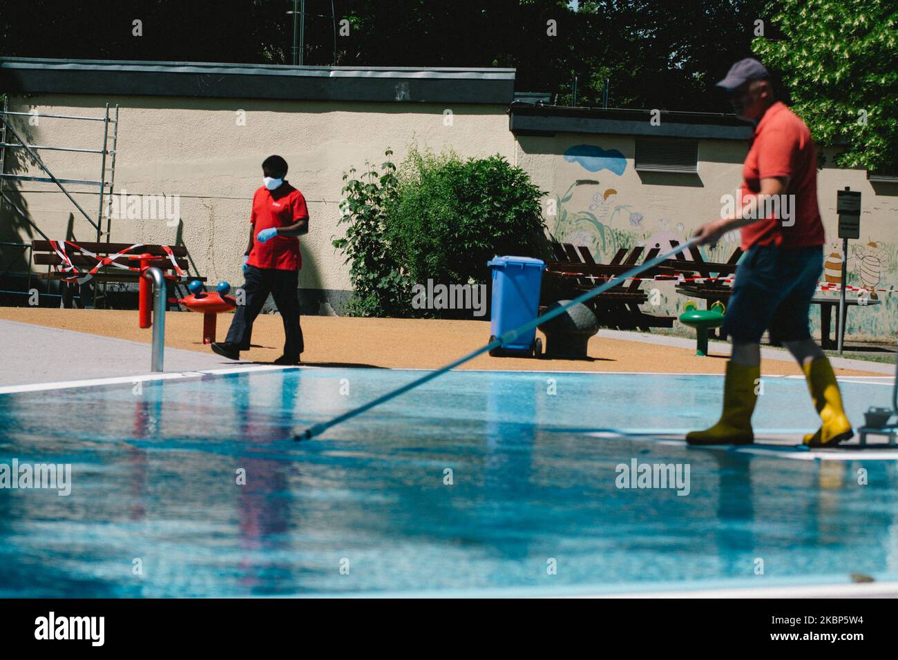 Cleaning crews clean the pool before Panoramabad swimming pool reopens ...