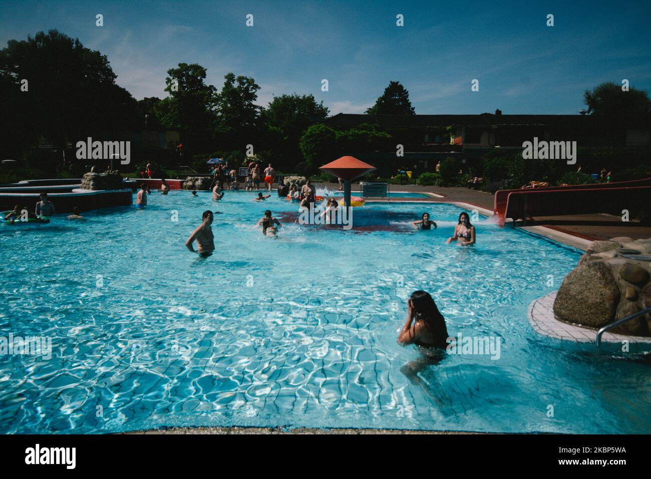 People relax inside the pool at the reopening day of Panoramabad ...