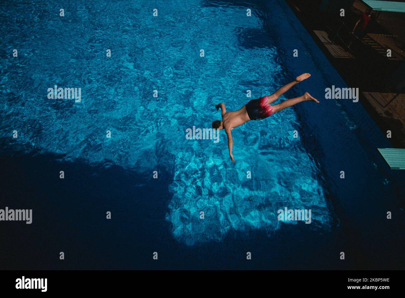 A boy jumps into the water at the reopening day of panoramabad swimming ...