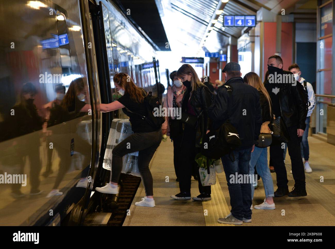 Passangers board the train at Krakow central train station. Polish ...