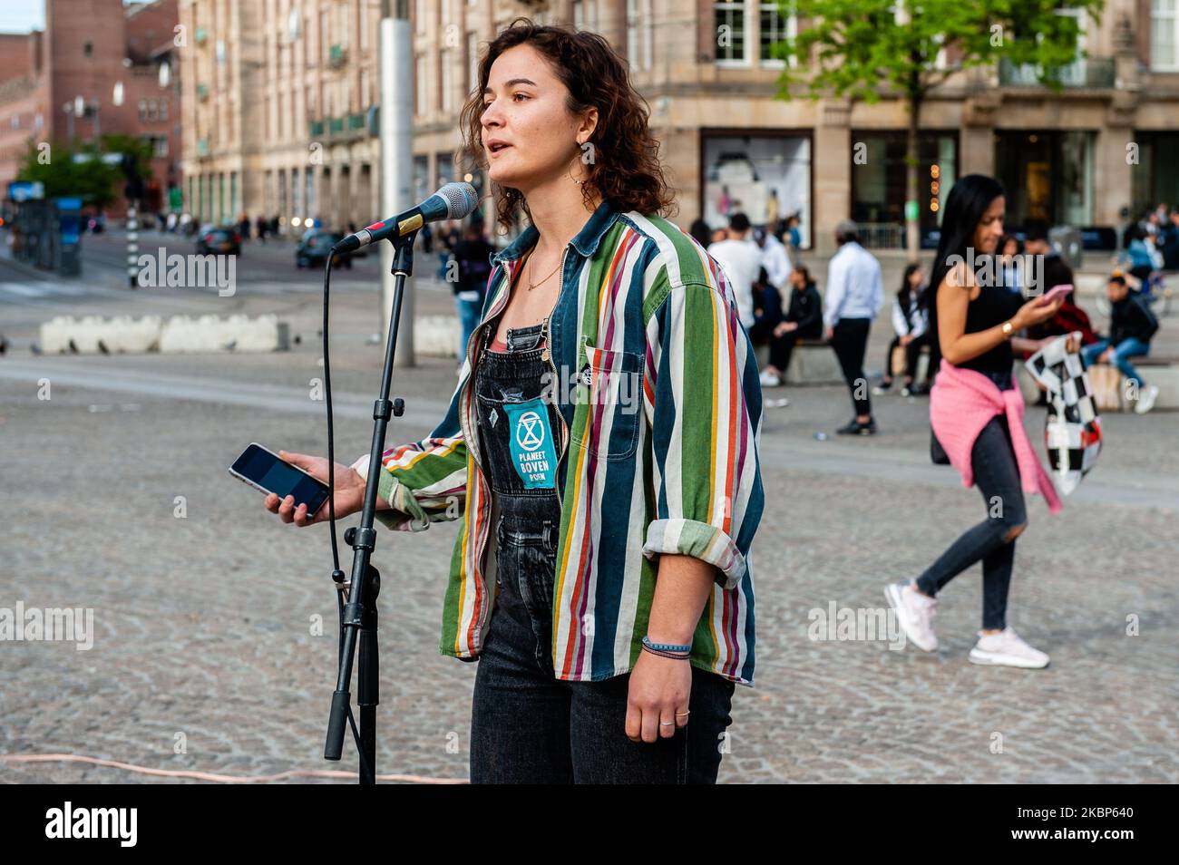 A XR activist is reading a powerful statement against fashion industry ...