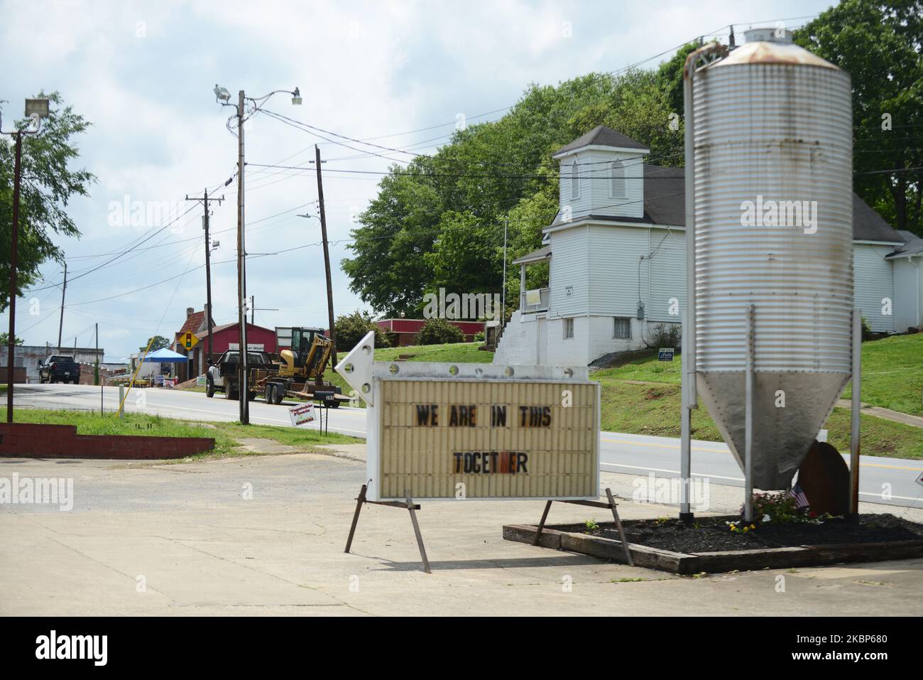 Farm equipment drives past an encouraging sign on the side of Route 29 ...