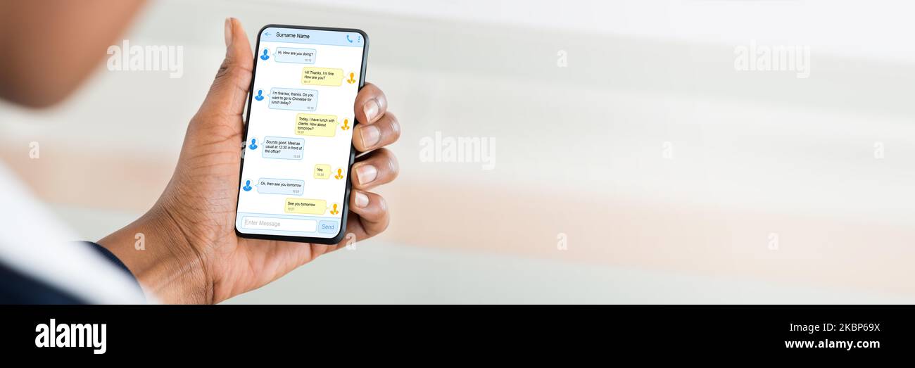 African Hand Holding Phone Checking SMS Message Stock Photo - Alamy