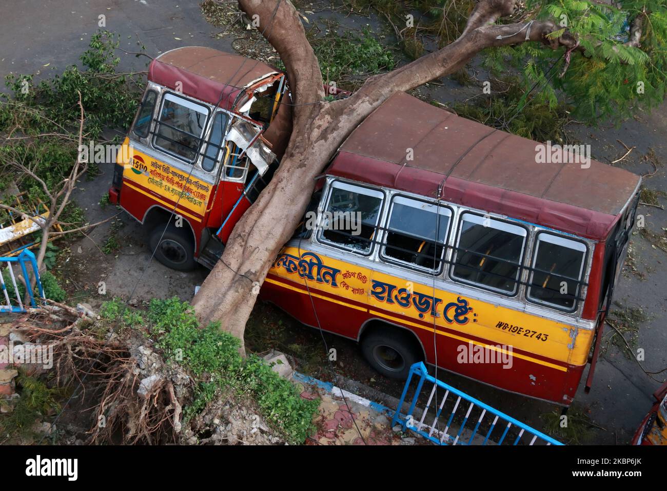 A Passenger bus damaged by a fallen tree due to Cyclone Amphan, is seen ...