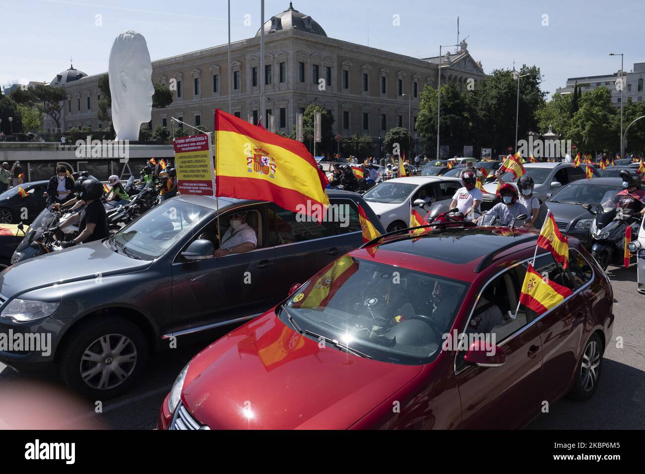 People holding Spanish flags take part on an in-vehicle protest against ...
