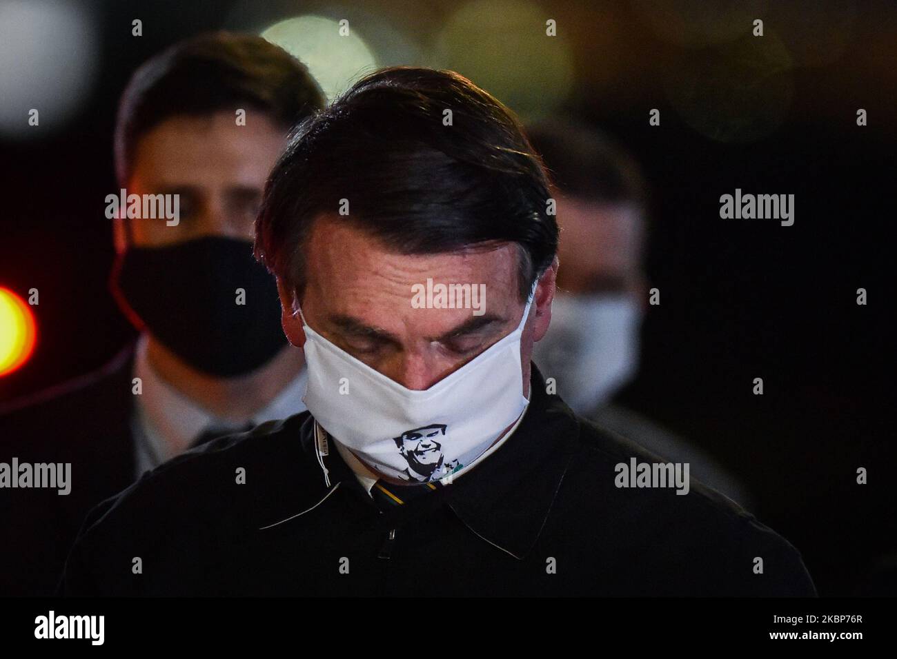 Wearing a protective face mask with his own image Brazil's president ...