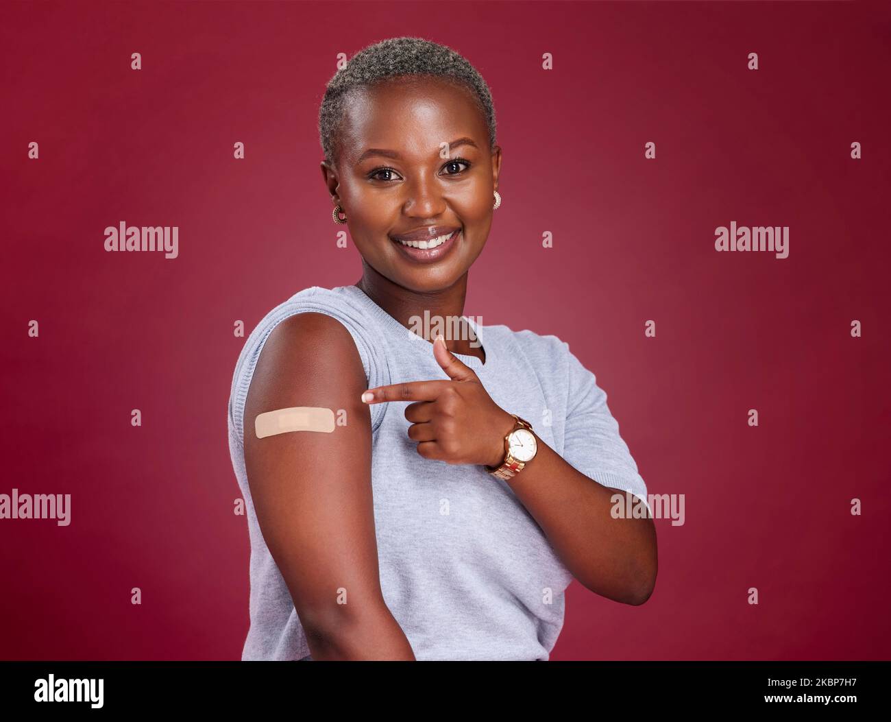 Black woman, pointing and covid plaster on studio red background for ...