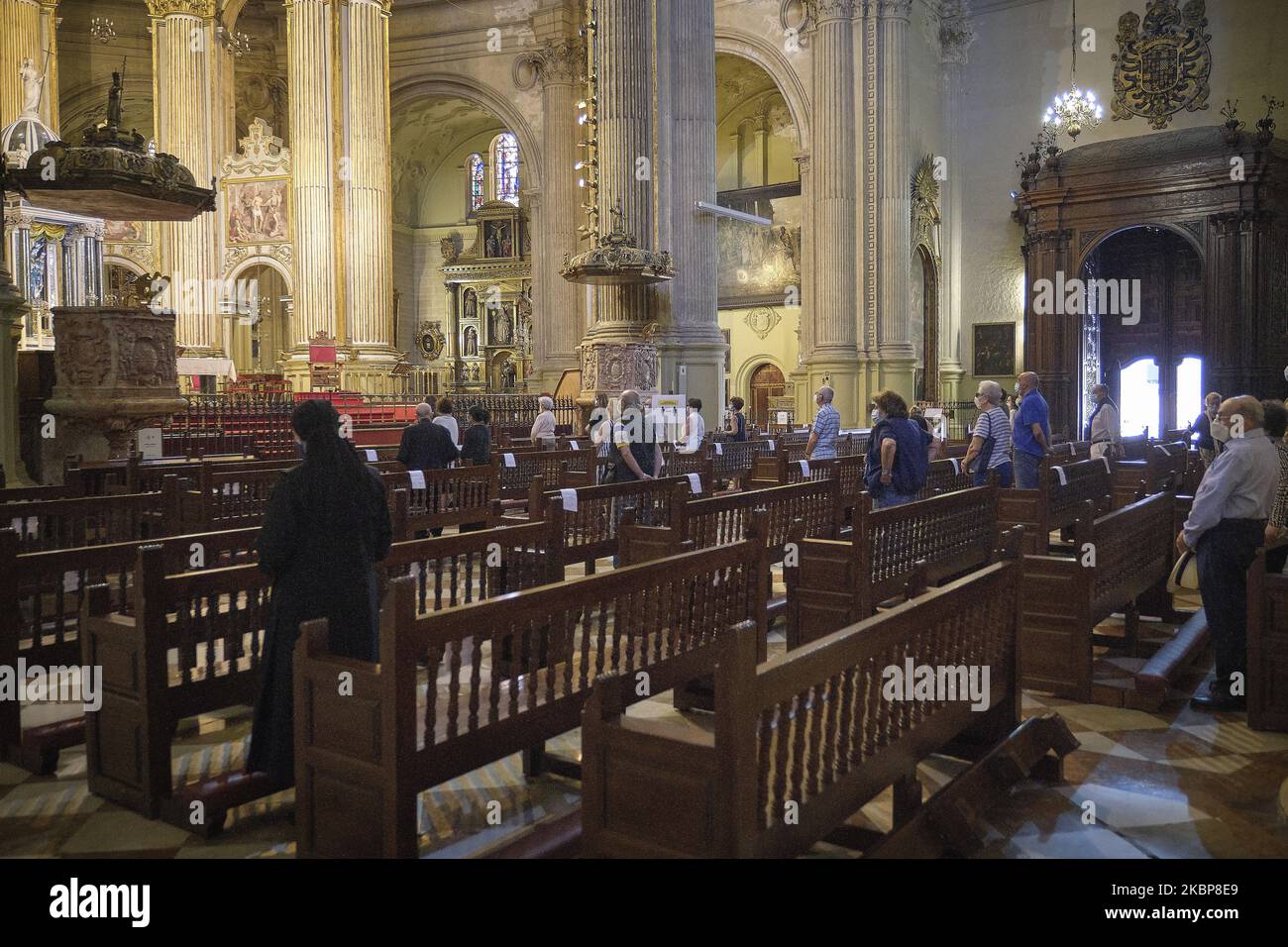 People inside of the cathedral respecting the health and safety ...