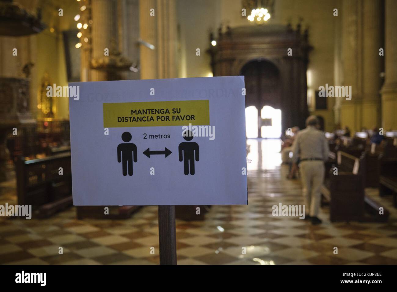 A sign inside of the cathedral displays the health and safety distance ...