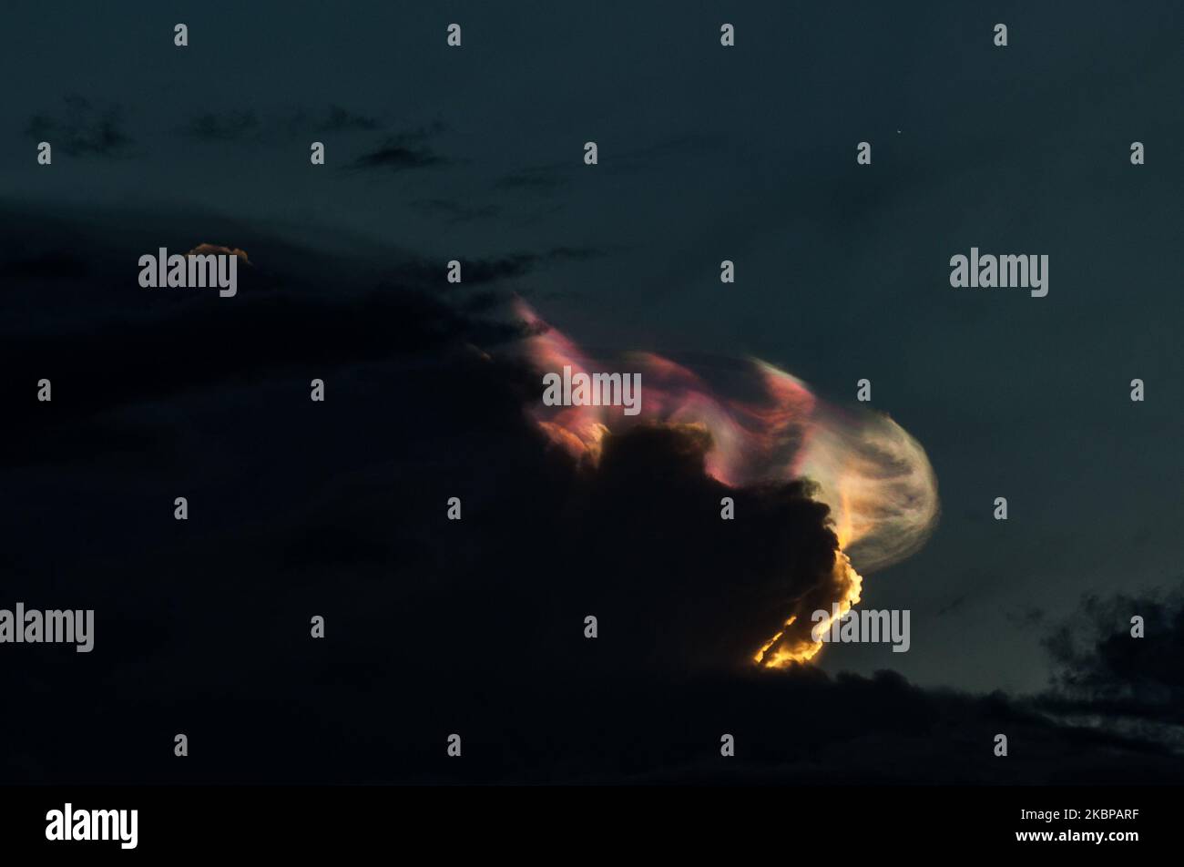 A colorful optical phenomenon called "Cloud Iridescence" is seen in the ...