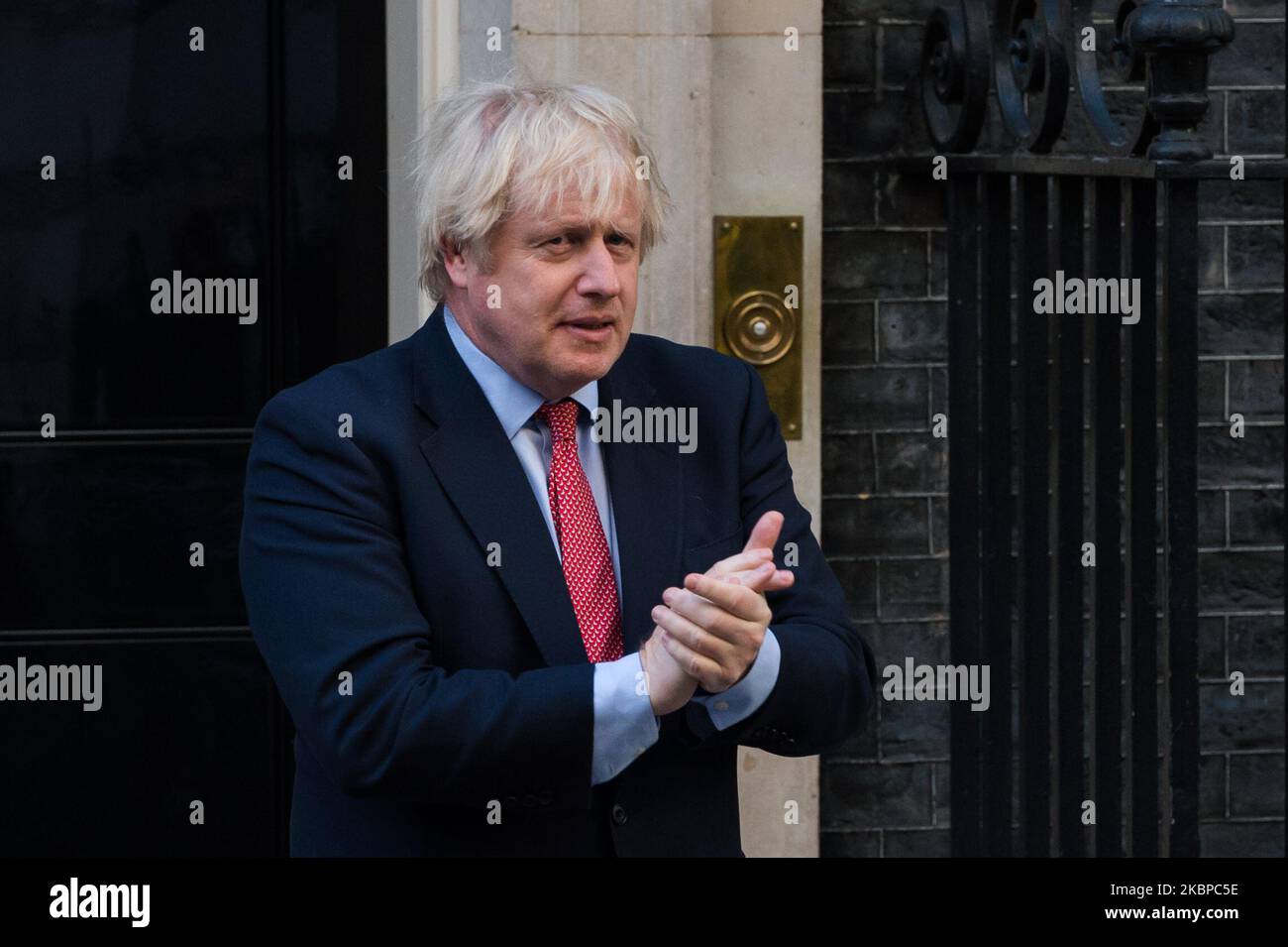 British Prime Minister Boris Johnson claps his hands outside 10 Downing ...