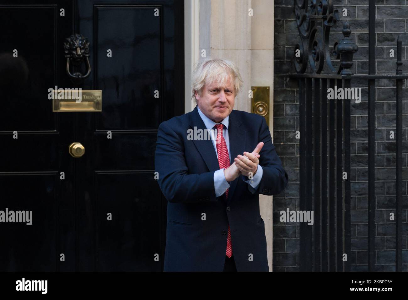 British Prime Minister Boris Johnson claps his hands outside 10 Downing ...