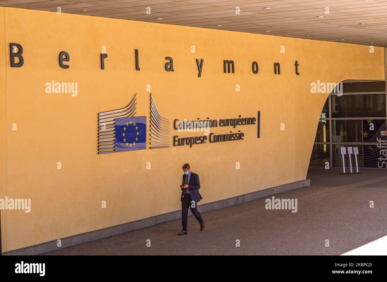 Pedestrian walking in front of the European Commission in Brussels ...