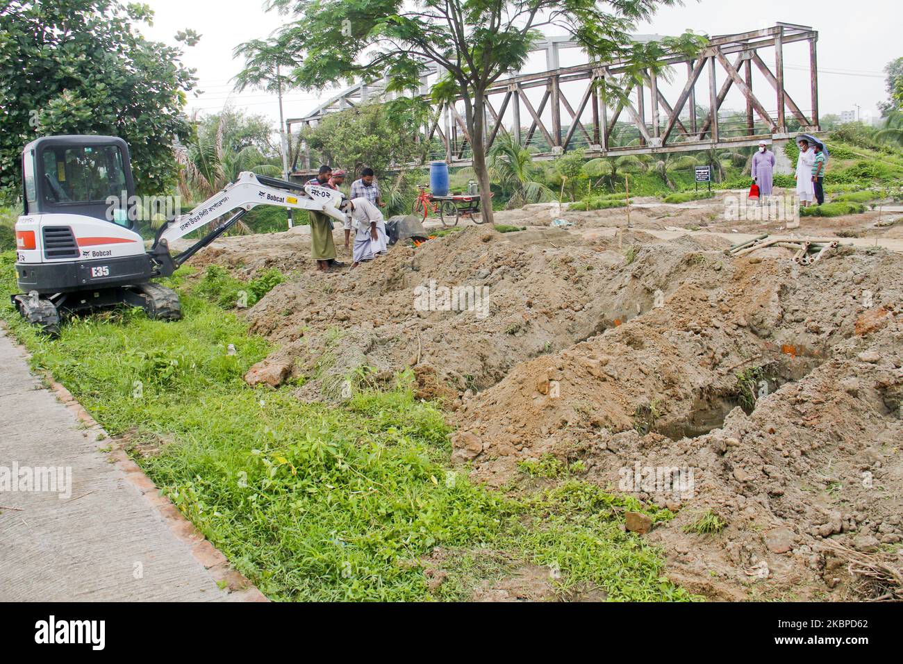 Excavator in continually digging new graves for the Corona victims in ...